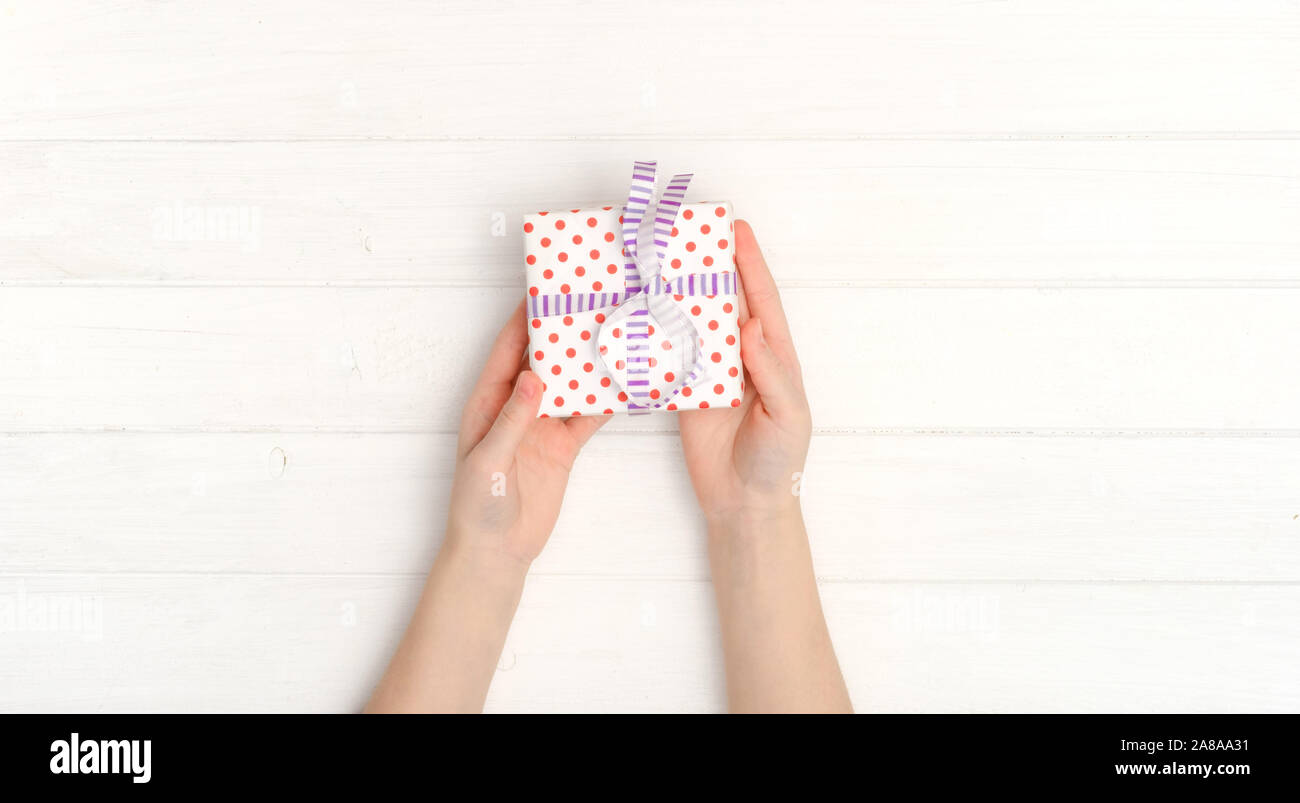 Little girl with small present in her hands Stock Photo - Alamy