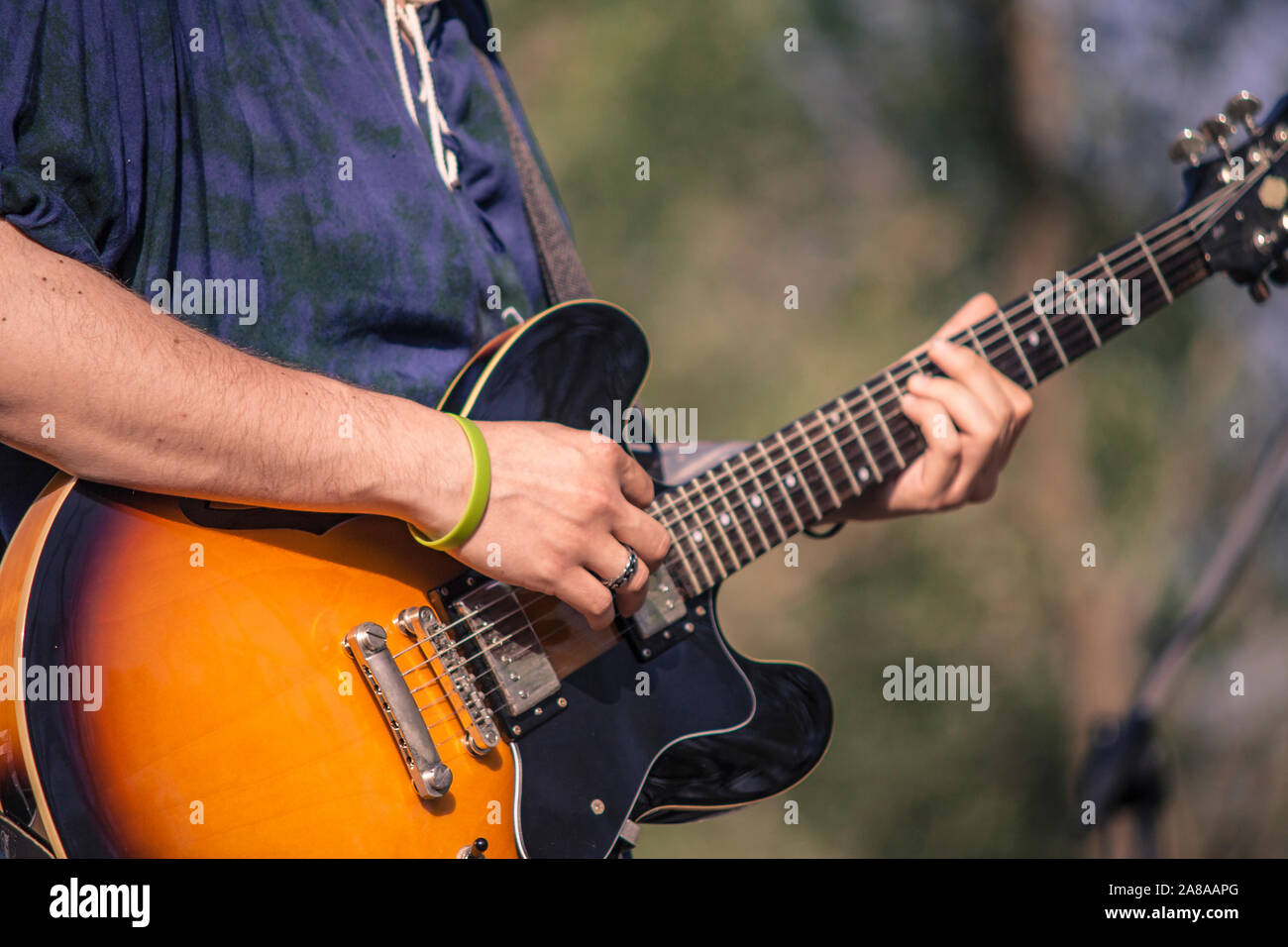 Detail of a rocker playing his electric guitar Stock Photo - Alamy