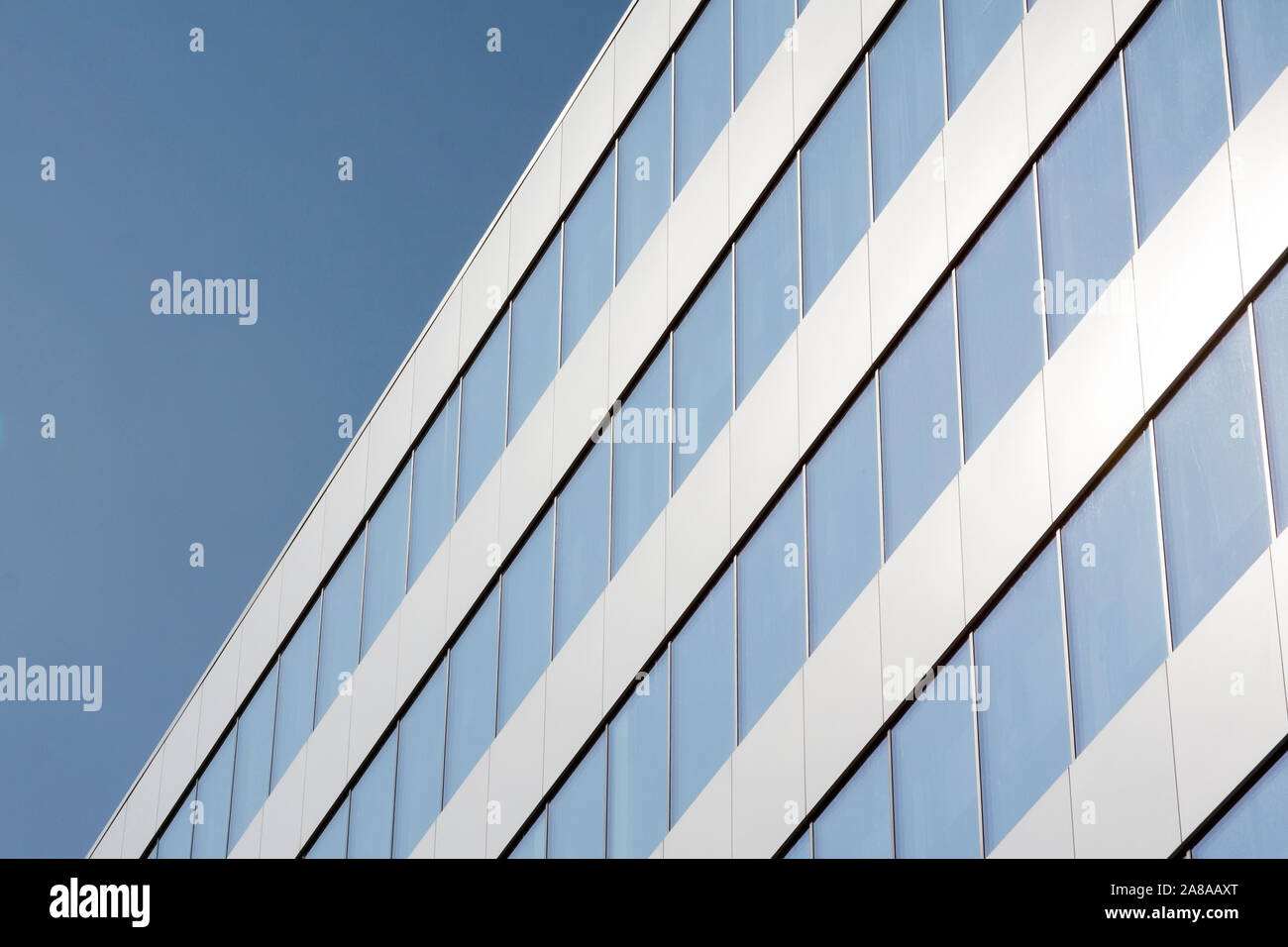 Abstract texture, rows of clean windows, clear blue sky as a background ...