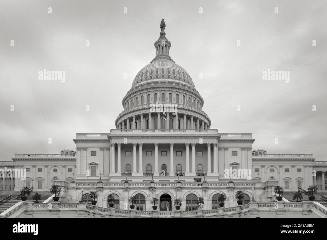 Western face of the US Capitol Building on a stormy day in black ...
