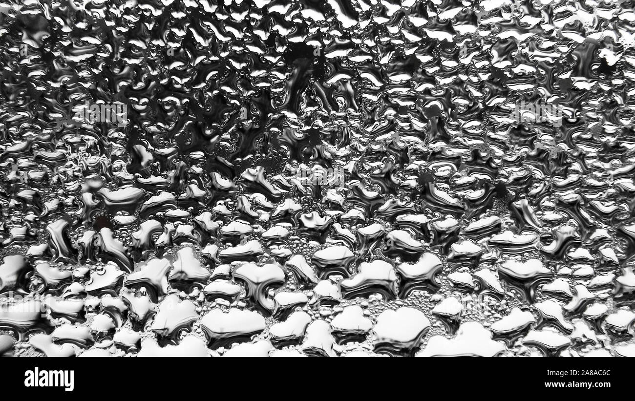 Raindrops collecting on a window to create a mosaic Stock Photo - Alamy