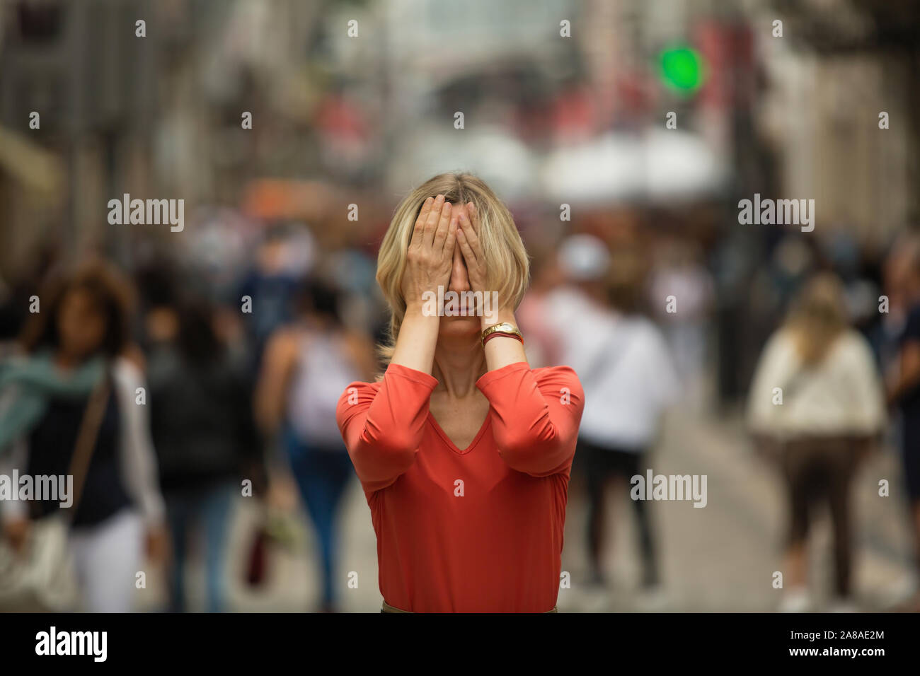 Panic attack in public place. Woman covers his eyes with his hands ...