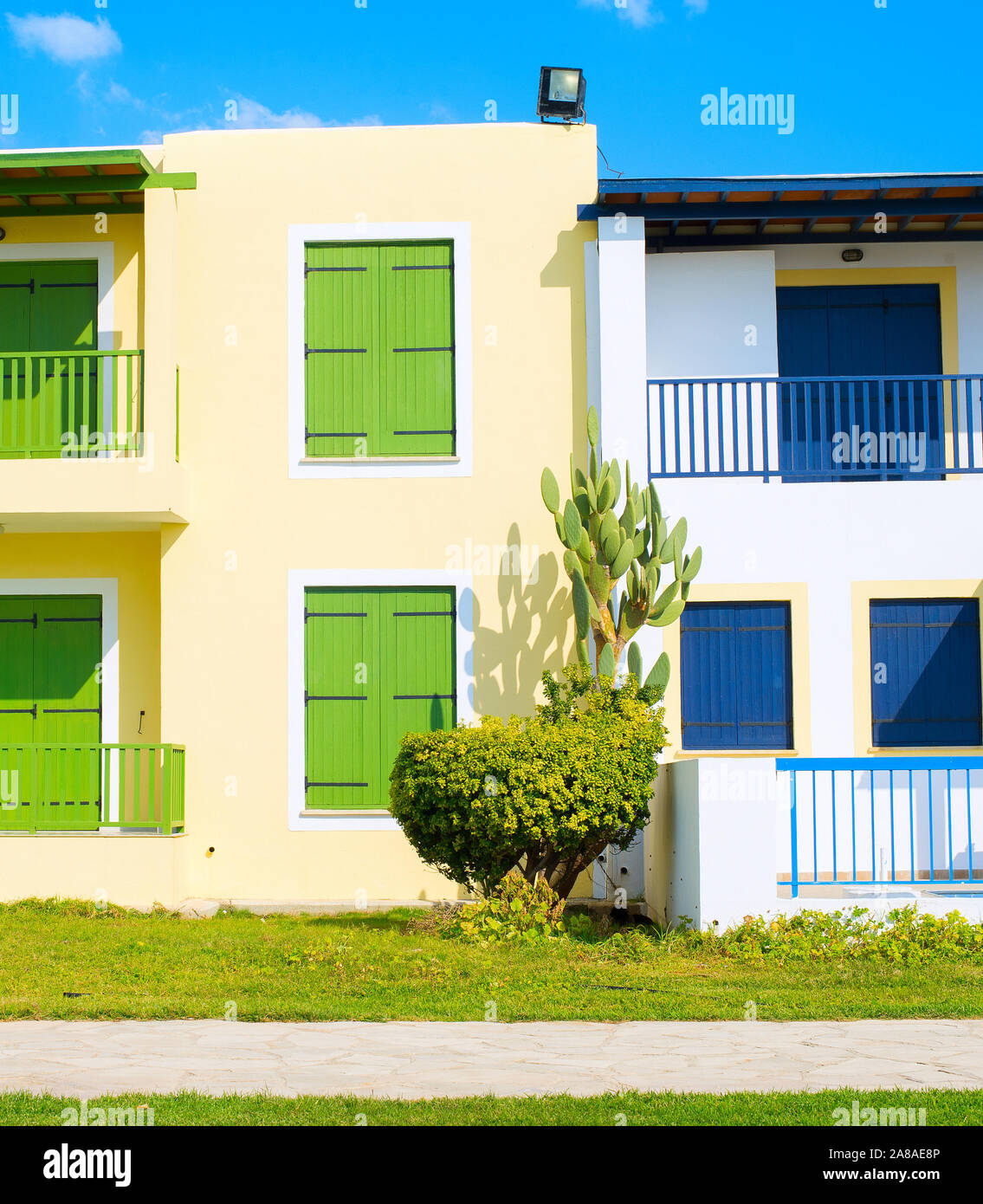Colorful tourist apartments in the sunny day. Front view. Paphos ...