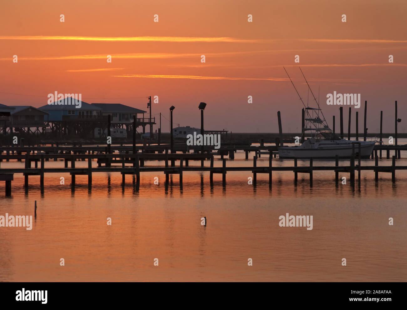 The sun sets on Grand Isle, a barrier island situated on the Gulf of ...