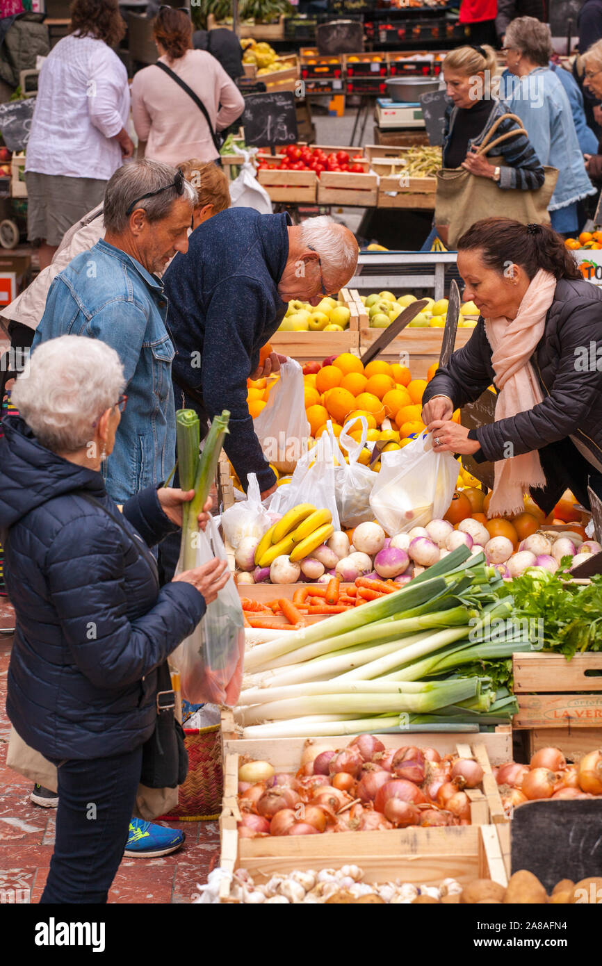 Men women people buying fresh fruit and vegetables from a market stall ...