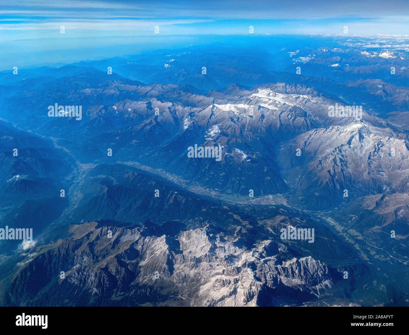 less and less snow on Alps from above by airplane Stock Photo - Alamy