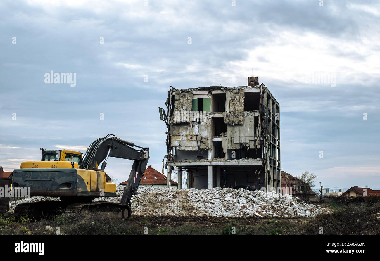 building under demolition with hydraulic excavator Stock Photo - Alamy