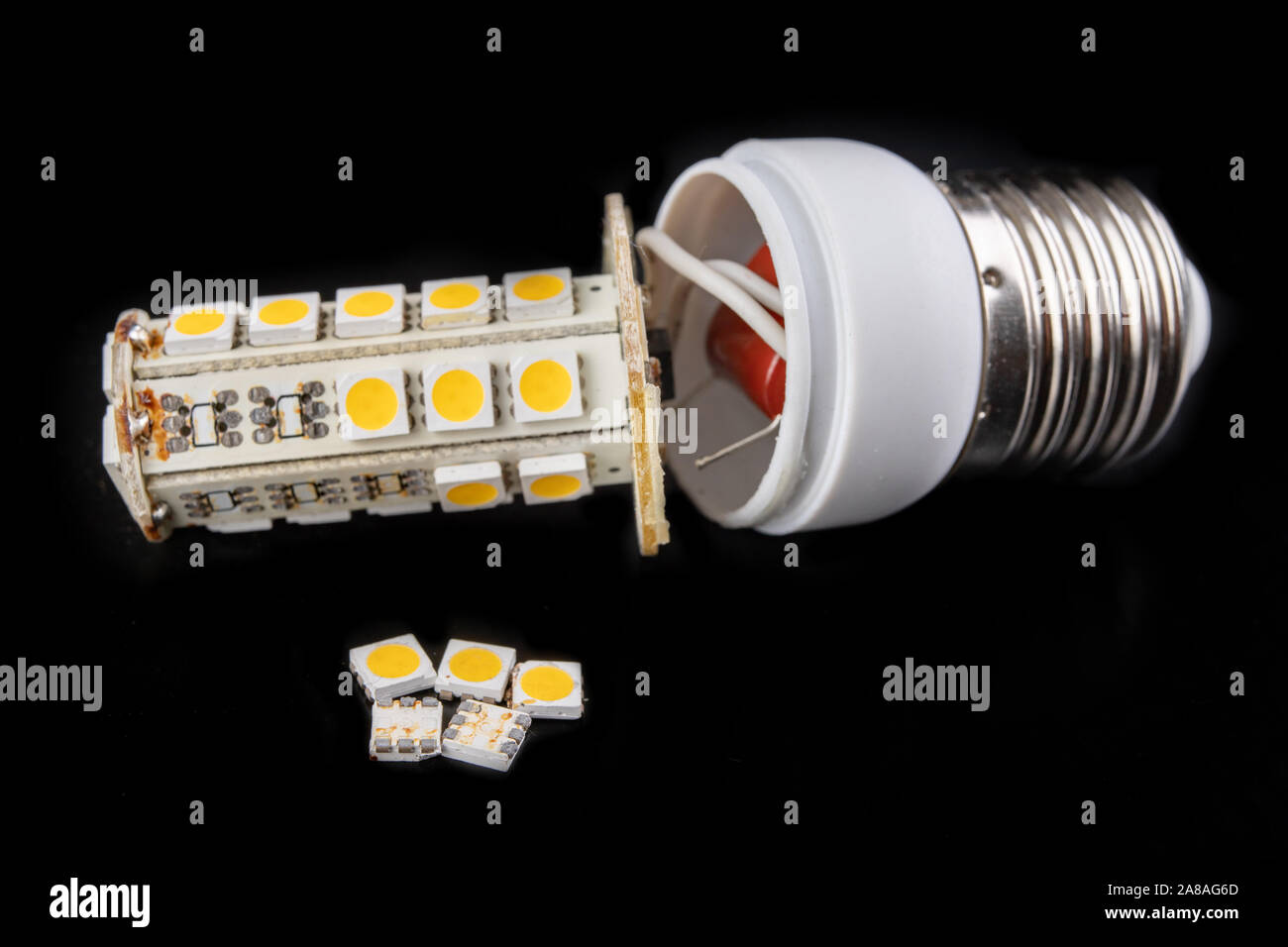 Broken led bulb on a dark table. Modern lighting under repair. Black ...