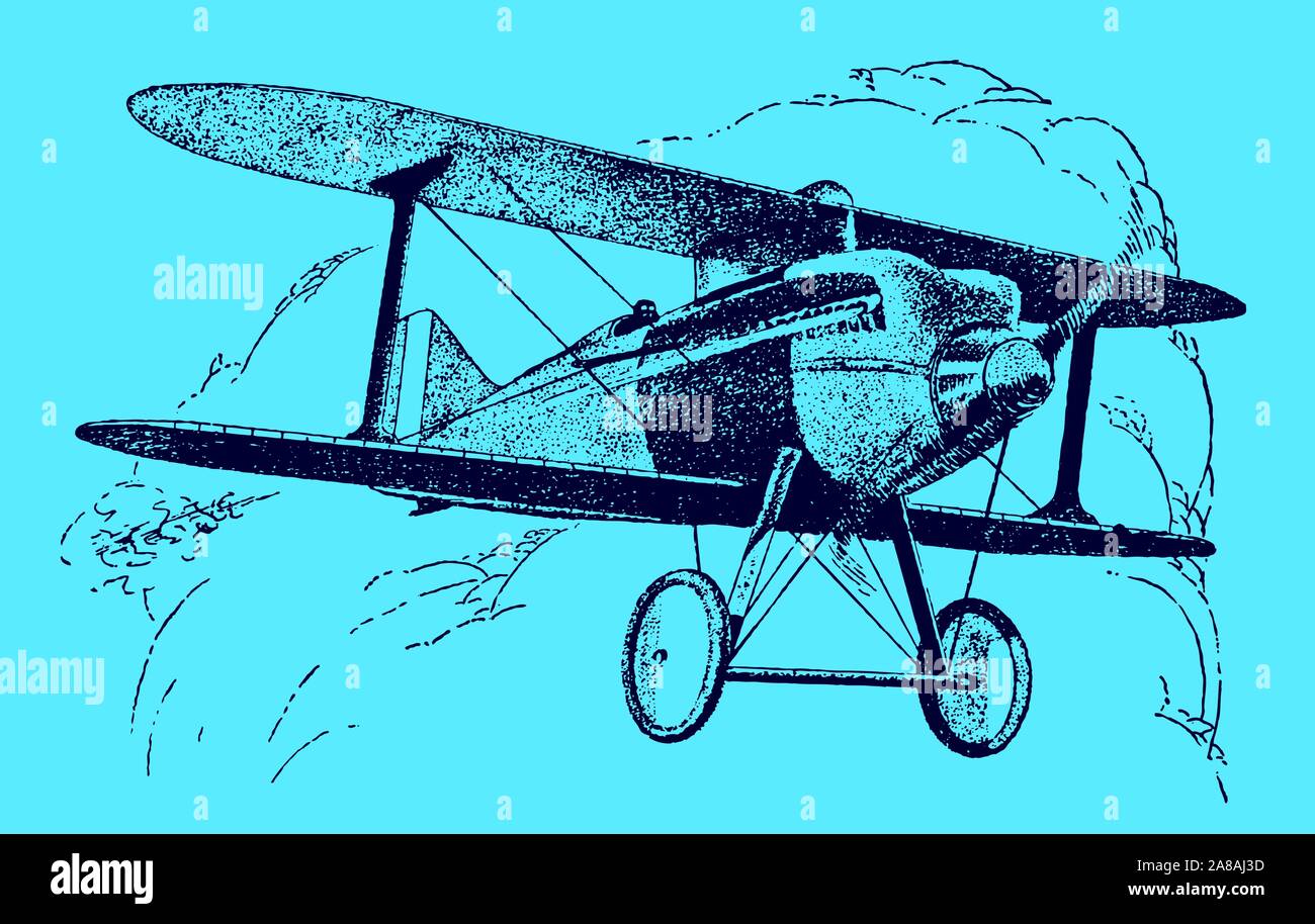 Historic racing biplane in front of large cumulus clouds on a blue ...