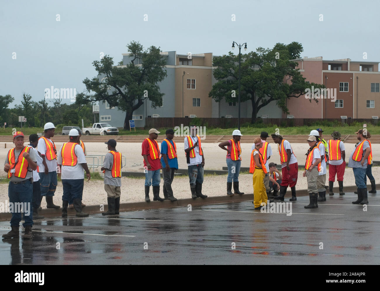 Oil spill cleanup workers await instruction on the beach in Gulfport ...