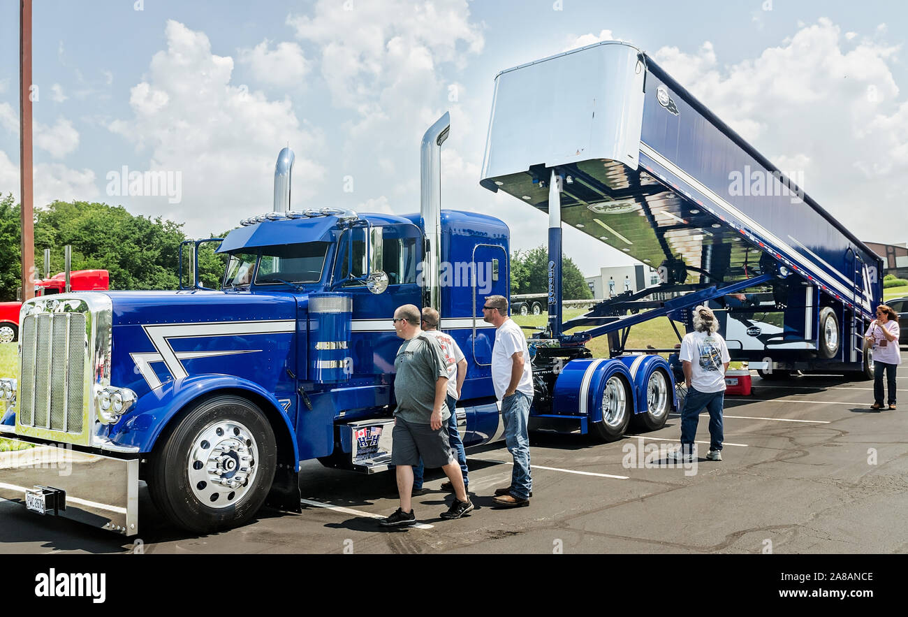 Truck enthusiasts examine a 2015 Peterbilt 389 with a 2017 MAC End Dump ...