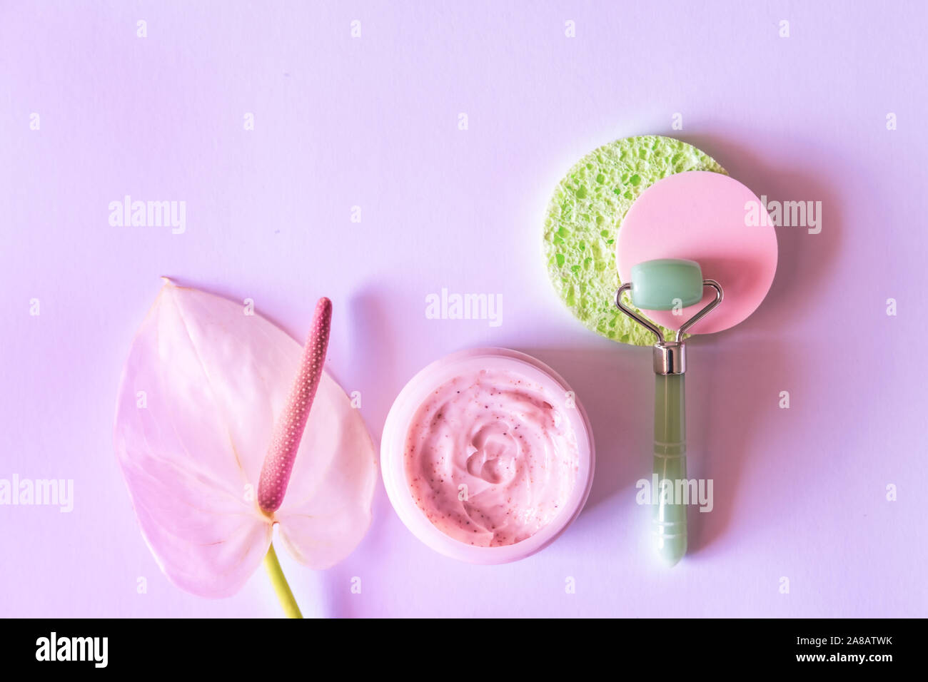 Scrub, roller and sponges on lilac background Stock Photo - Alamy