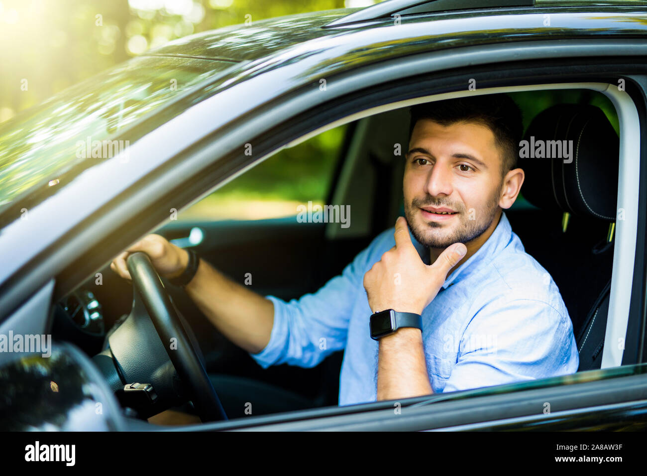 Portrait of an handsome guy driving his car Stock Photo - Alamy