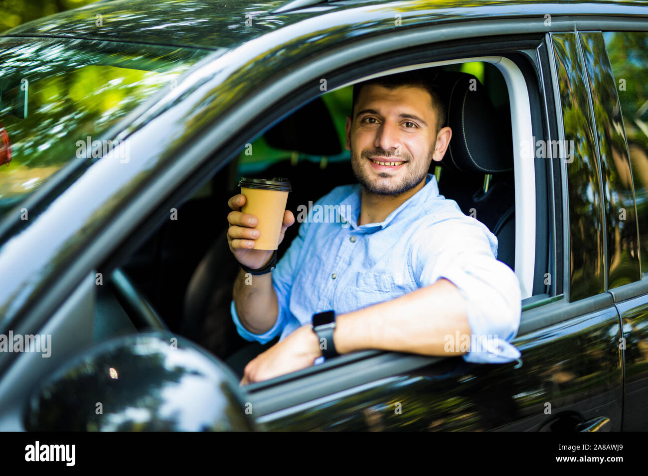 Man drinking coffee while driving the car Stock Photo - Alamy