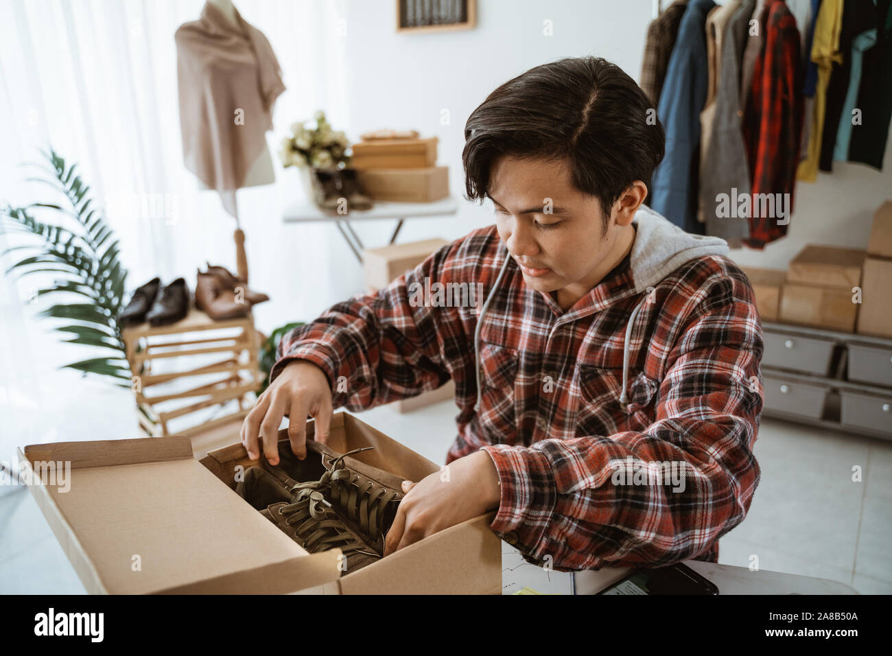 Young entrepreneur preparing parcel hi-res stock photography and images ...