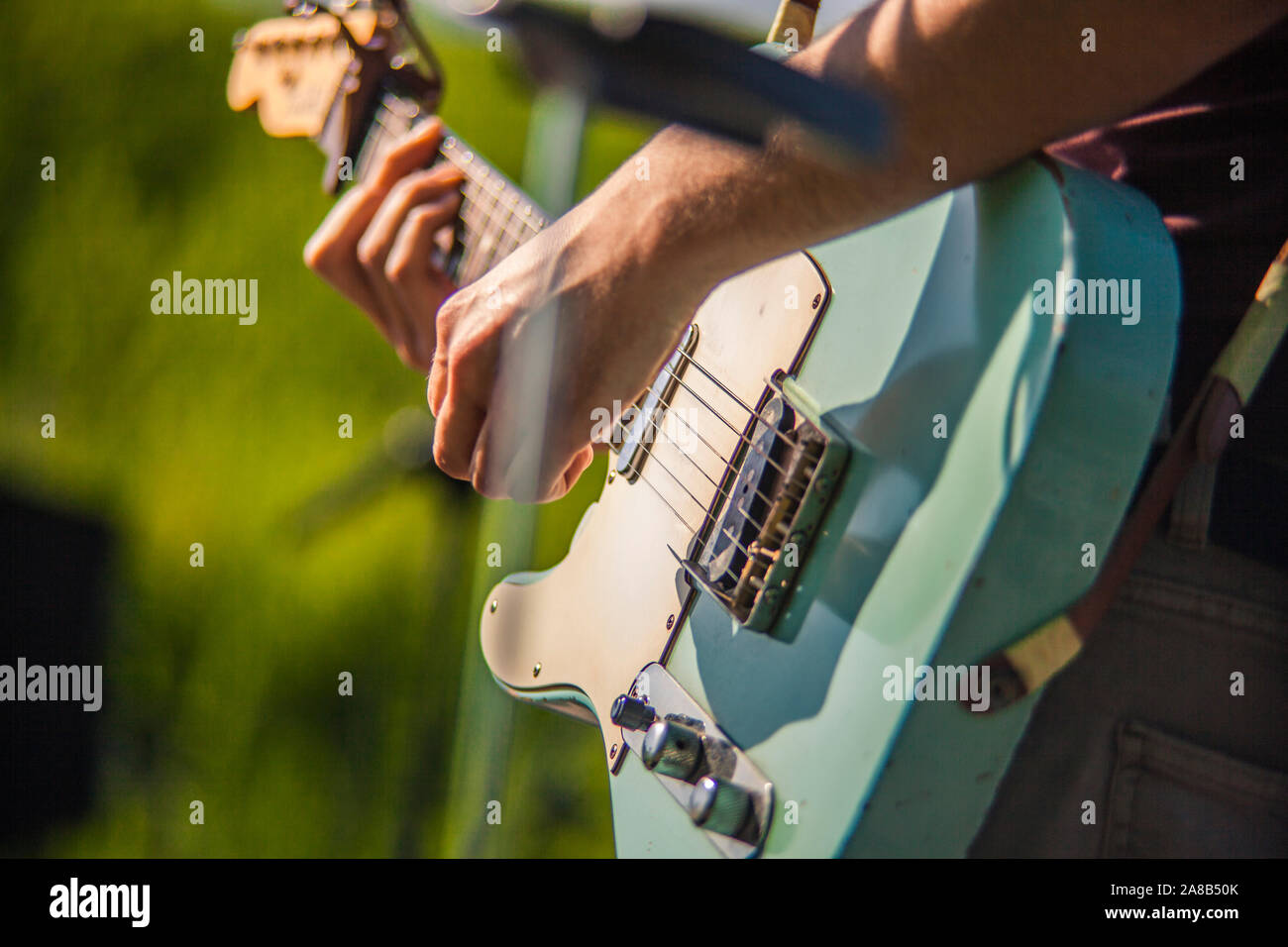 Rocker musician plays electric guitar #2 Stock Photo - Alamy