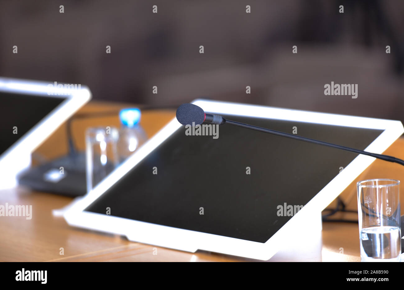 Microphones and monitors at conference hall during business conference ...