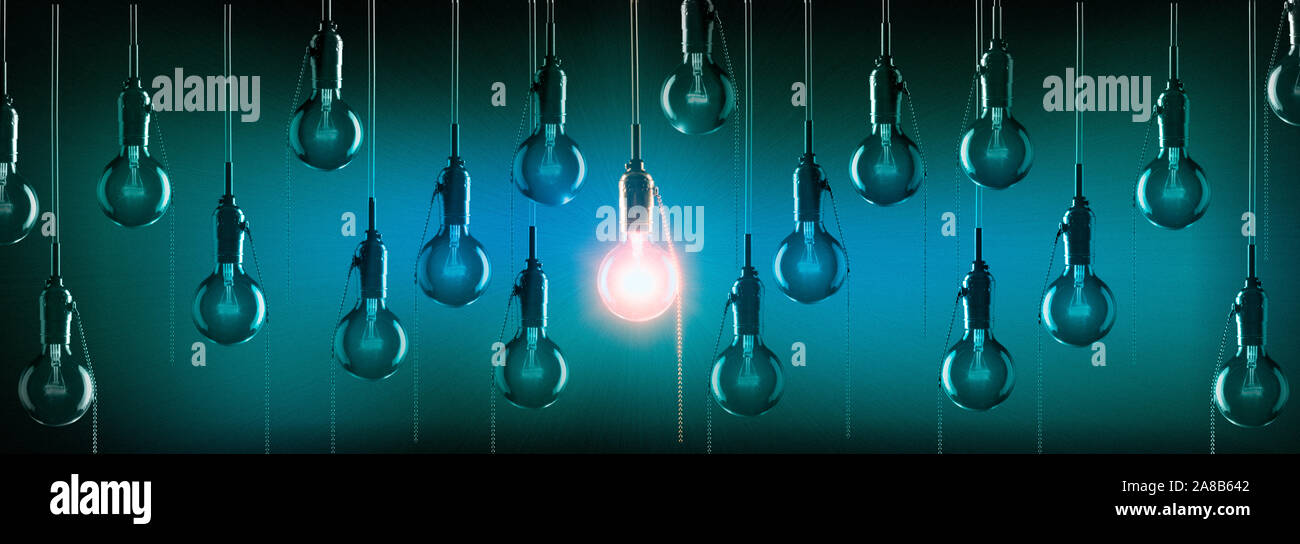 Light bulb lit up with unlit light bulbs Stock Photo - Alamy