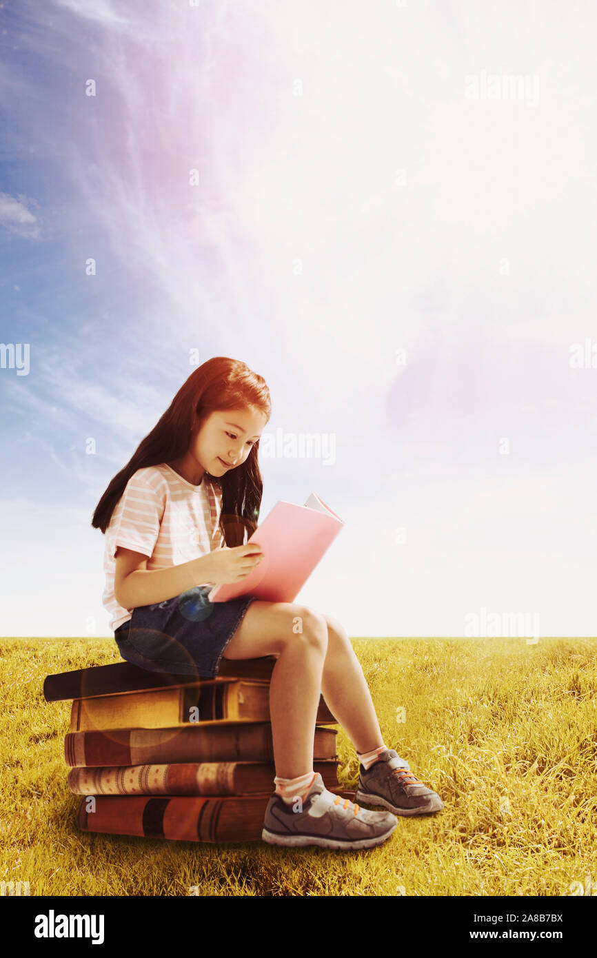 happy little girl studying on the books Stock Photo - Alamy
