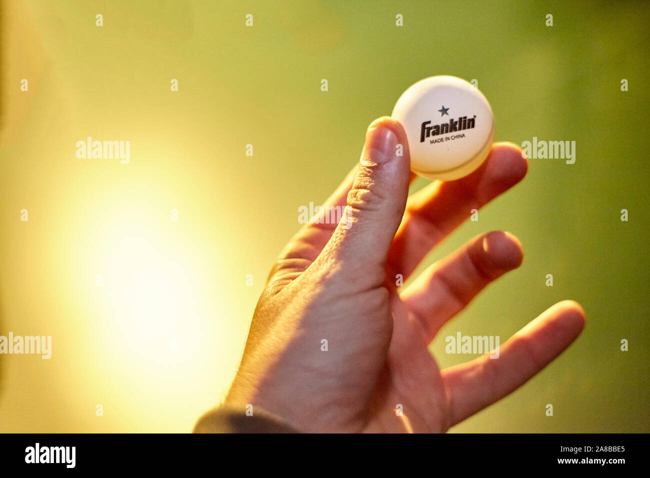 Hand holding a ping pong ball Stock Photo - Alamy