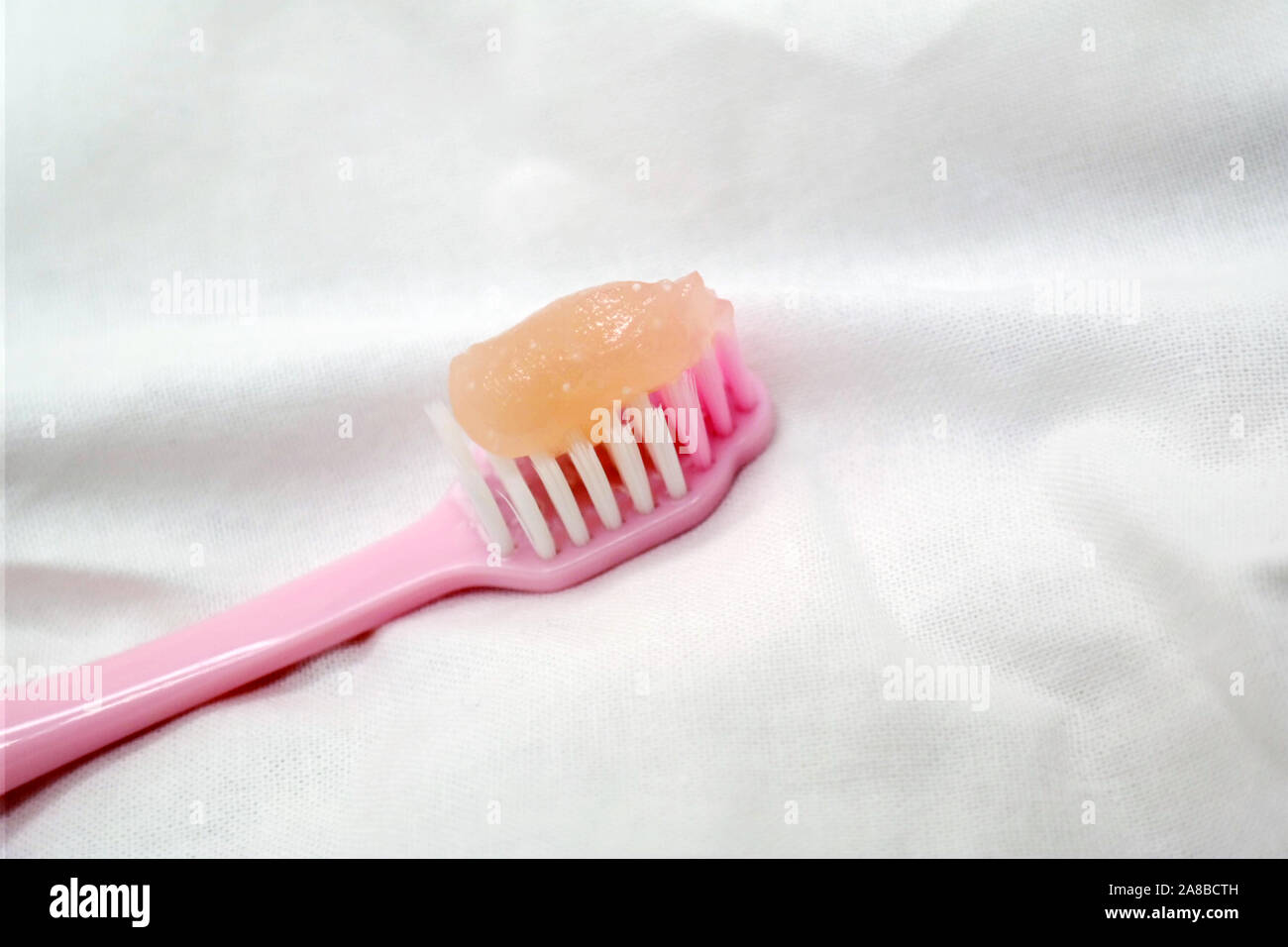 Pink Salt Toothpaste On The Toothbrush Stock Photo - Alamy