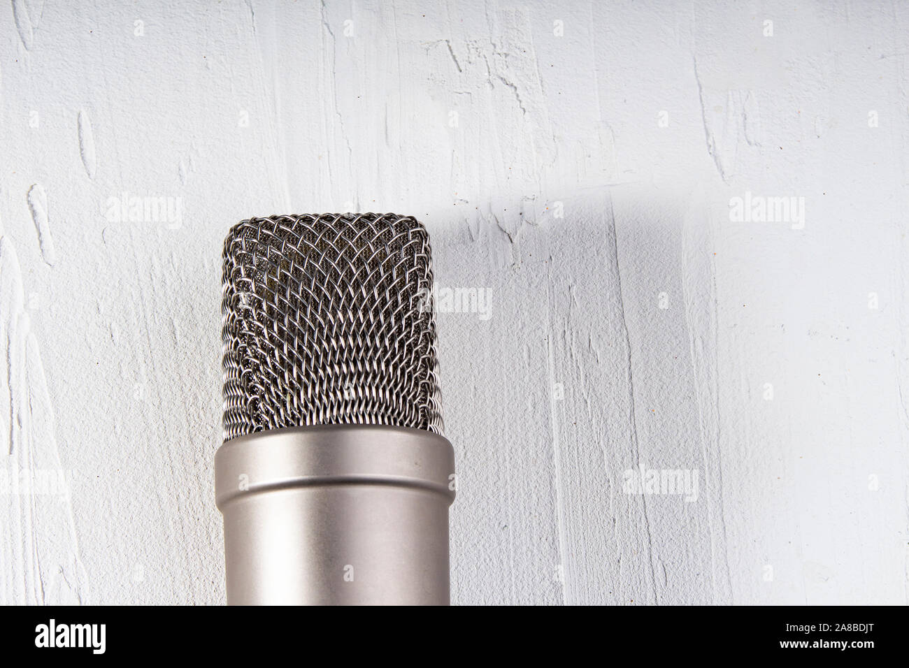 Microphone on lay on a texture background with a light Stock Photo - Alamy