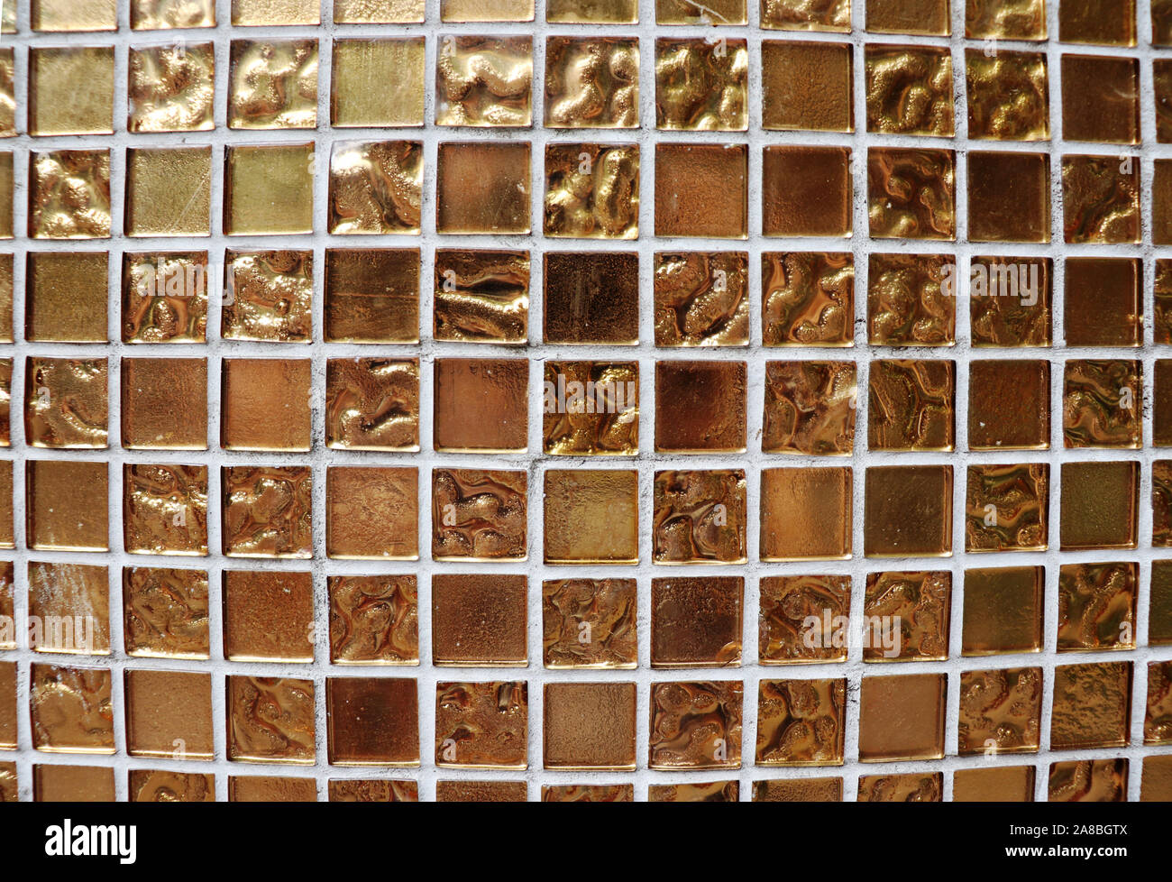 Golden glass mosaic tile exterior texture background Stock Photo - Alamy