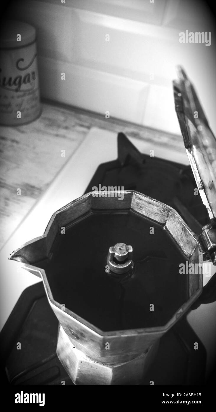 Italian aluminum small opened coffee pot full of black coffee on a ...