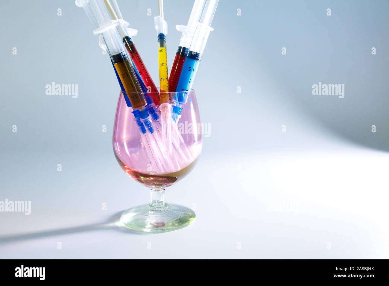 Set of medical syringes in a glass with colored injections for ...