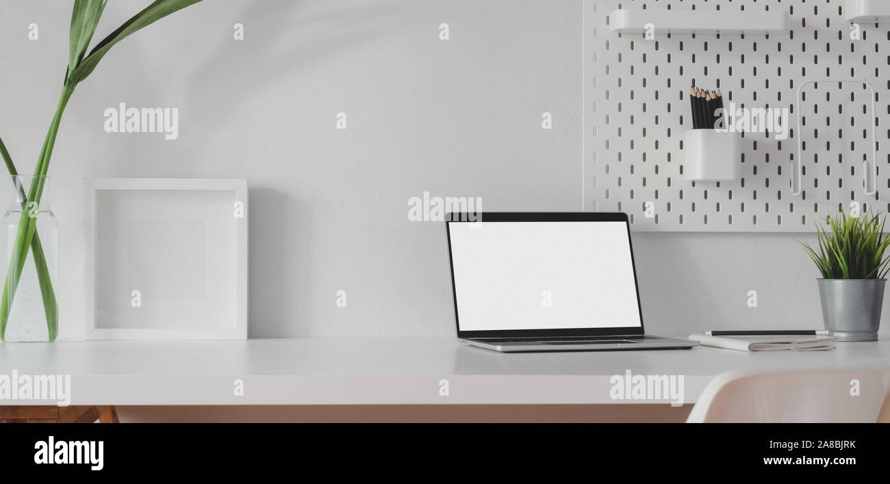 Minimal workspace with open blank screen laptop computer and mock up ...