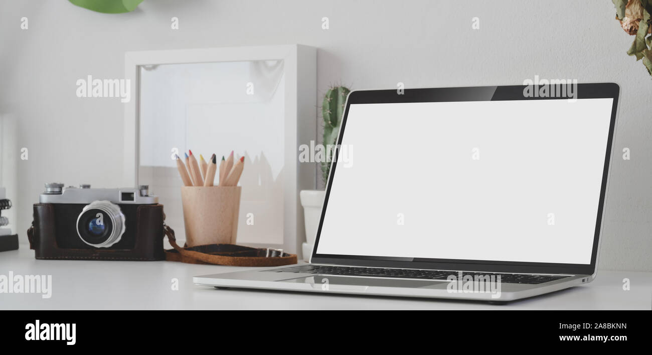 Open blank screen laptop computer in photographer workplace with office ...