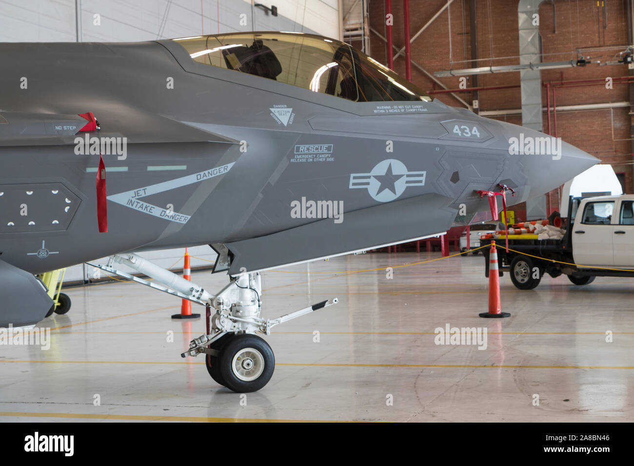 A USMC F-35B Lightning II sits on static display while being guarded at ...