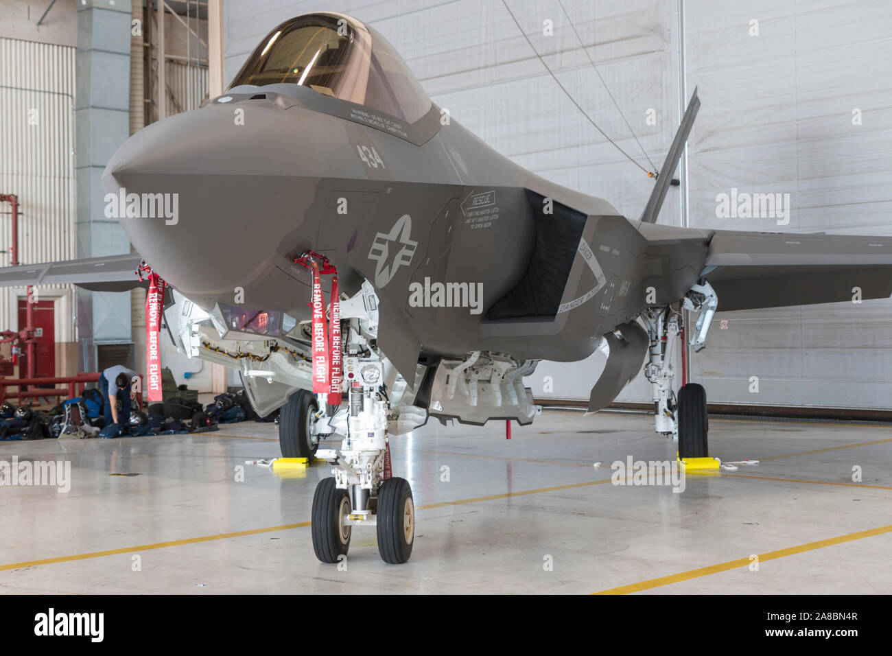 A USMC F-35B Lightning II sits on static display while being guarded at ...