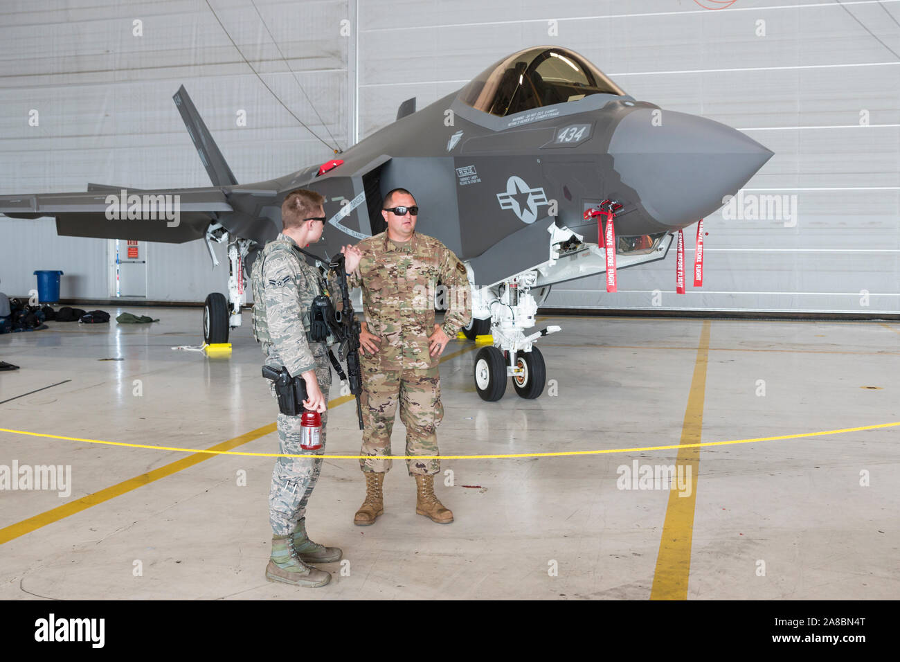 A USMC F-35B Lightning II sits on static display while being guarded at ...