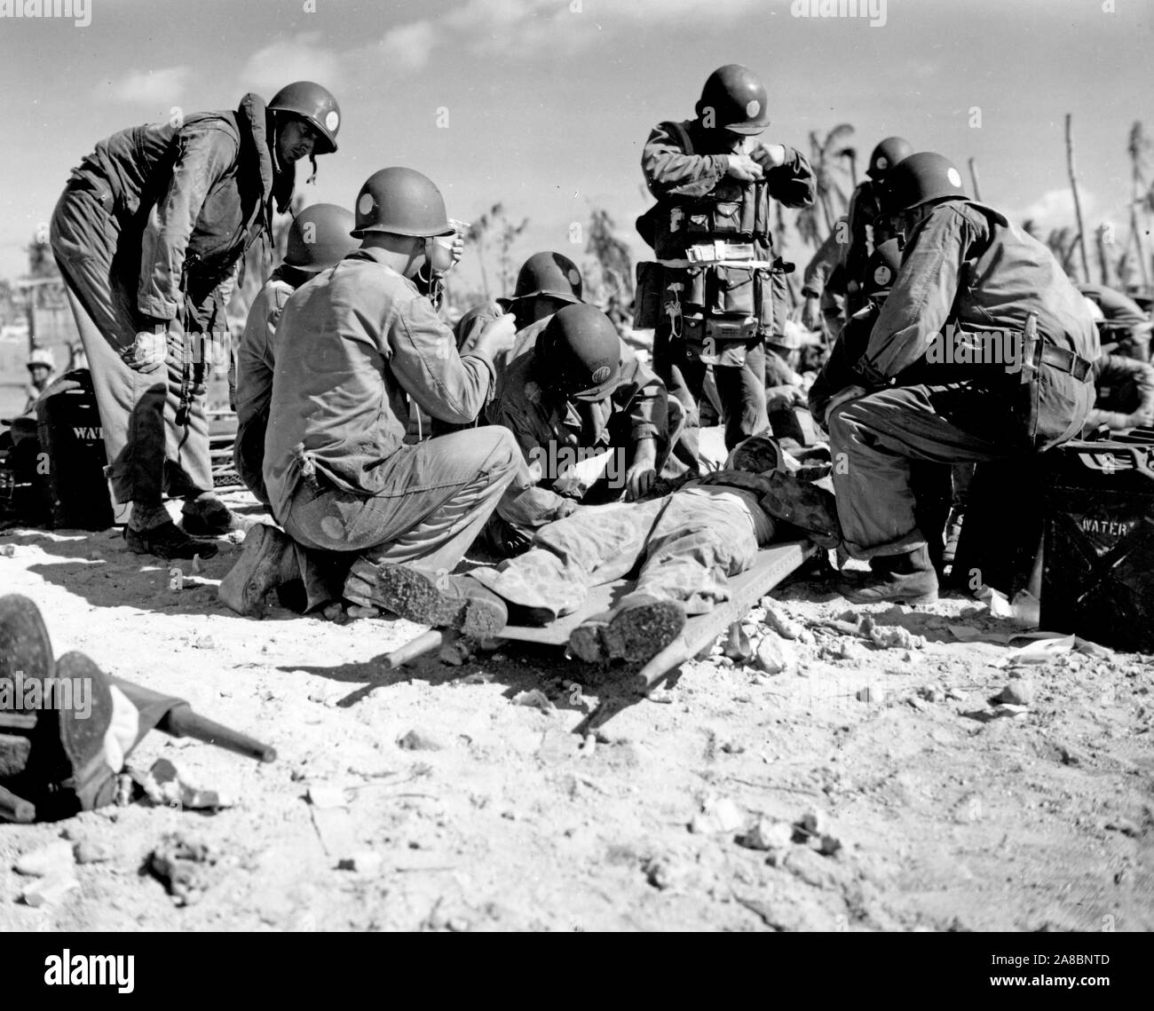 World War II Photo - Blood plasma given to wounded marine on beach of ...