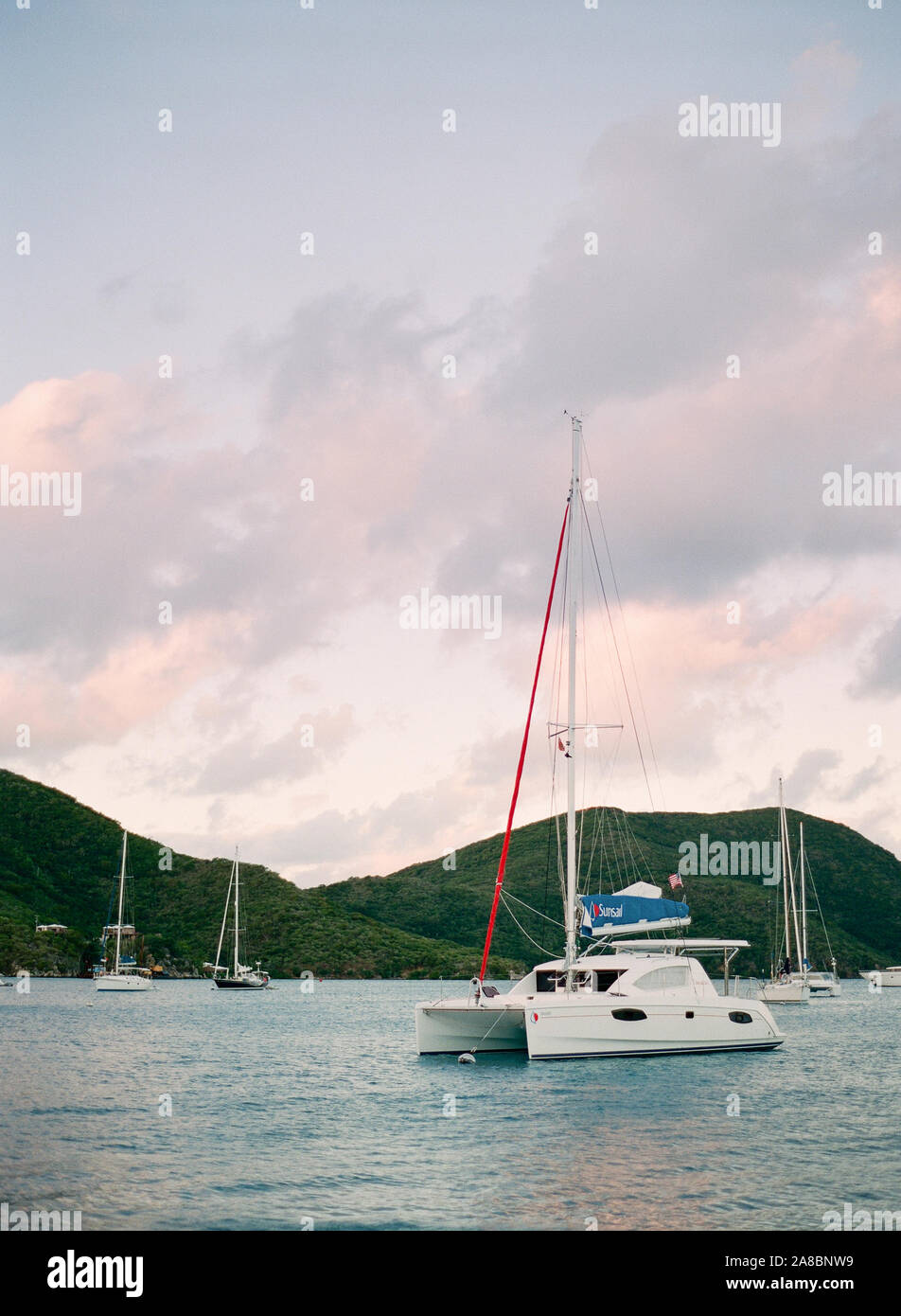 White catamaran sailboat at sunset in the harbor at the Bitter End ...