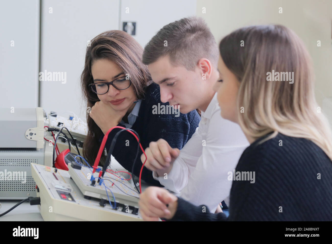 Three young students in technical vocational training, the lesson in ...