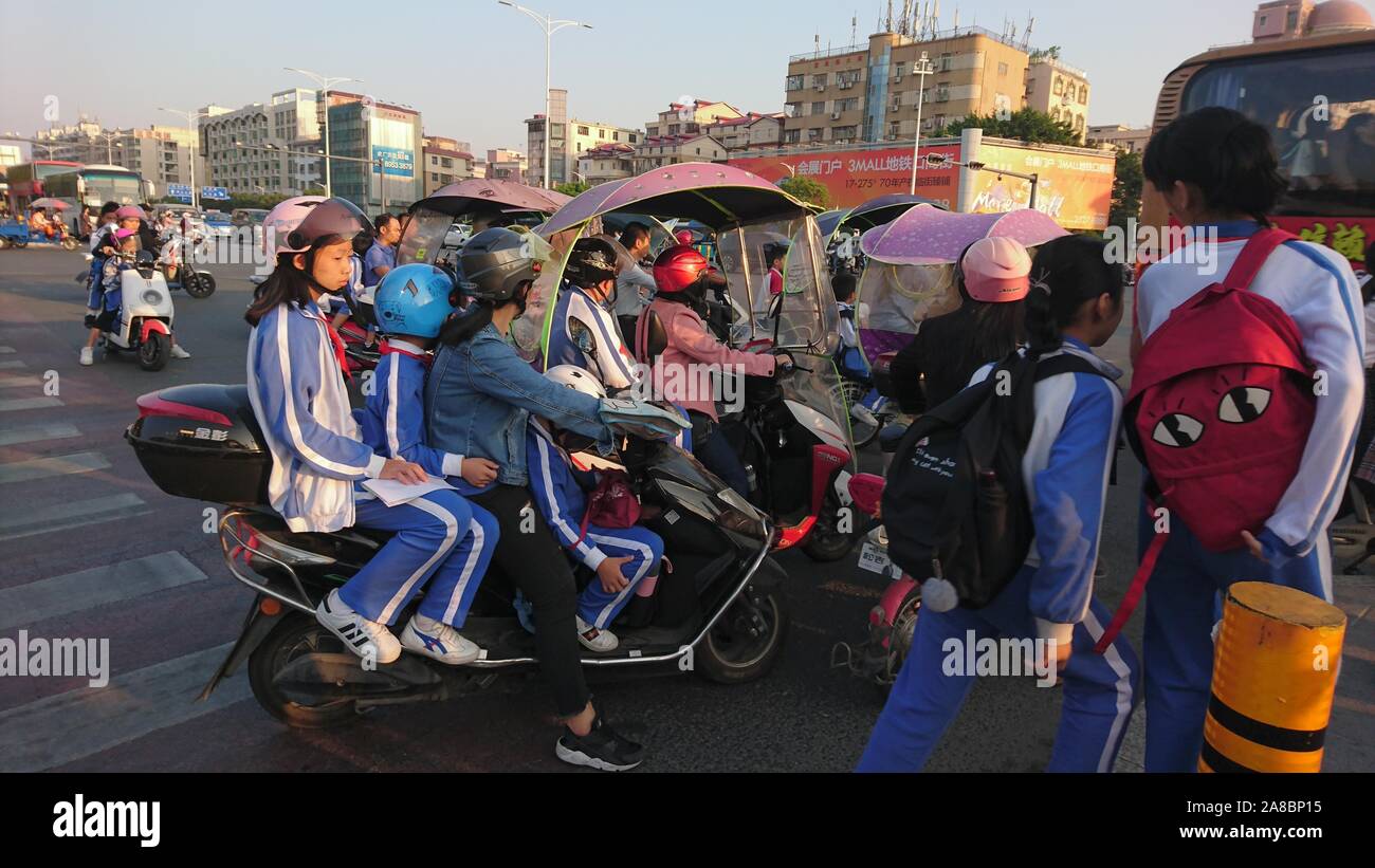 Shenzhen, China: parents ride their children to school on electric ...