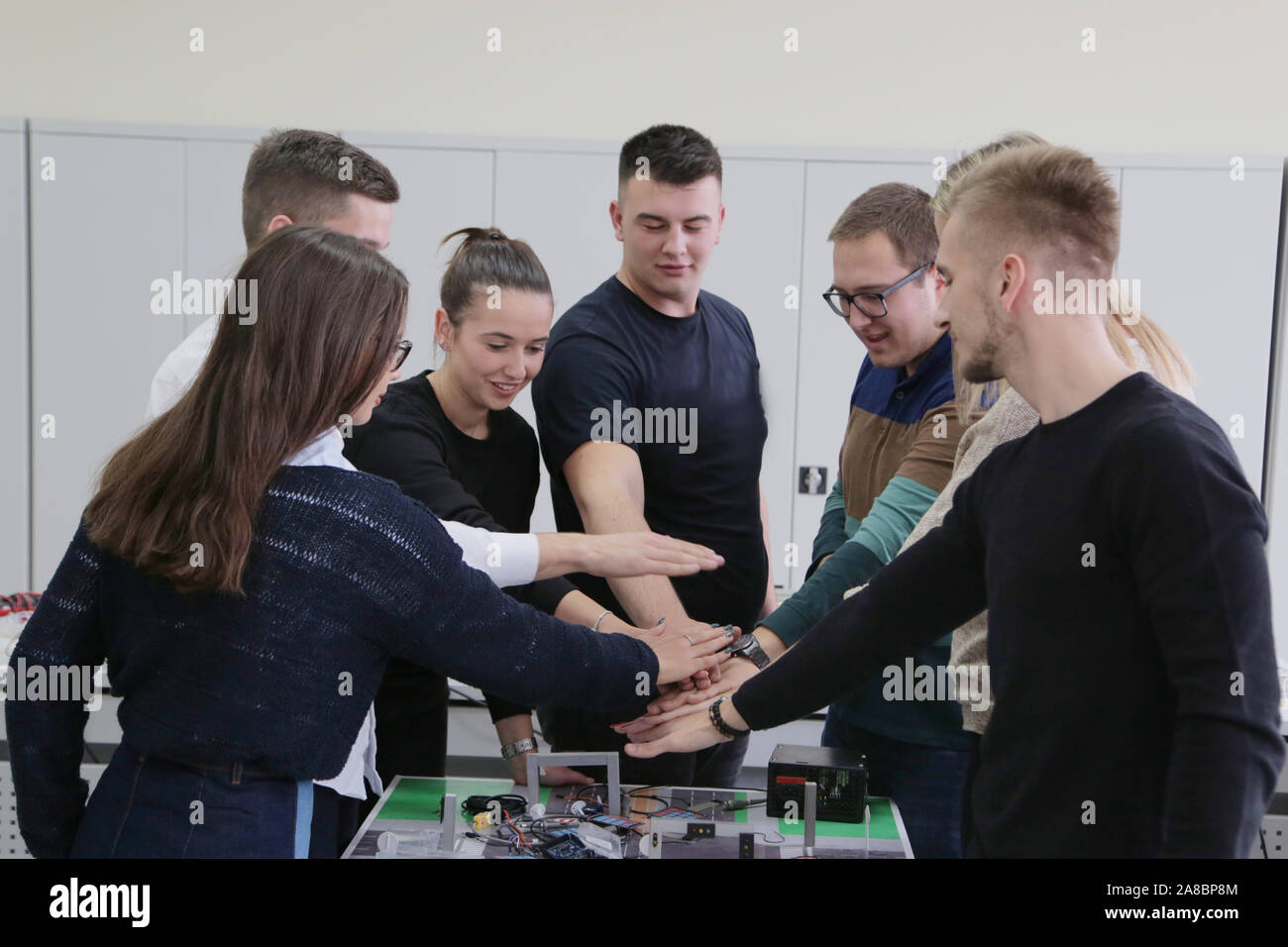 Group of young students in technical vocational training celebrating ...