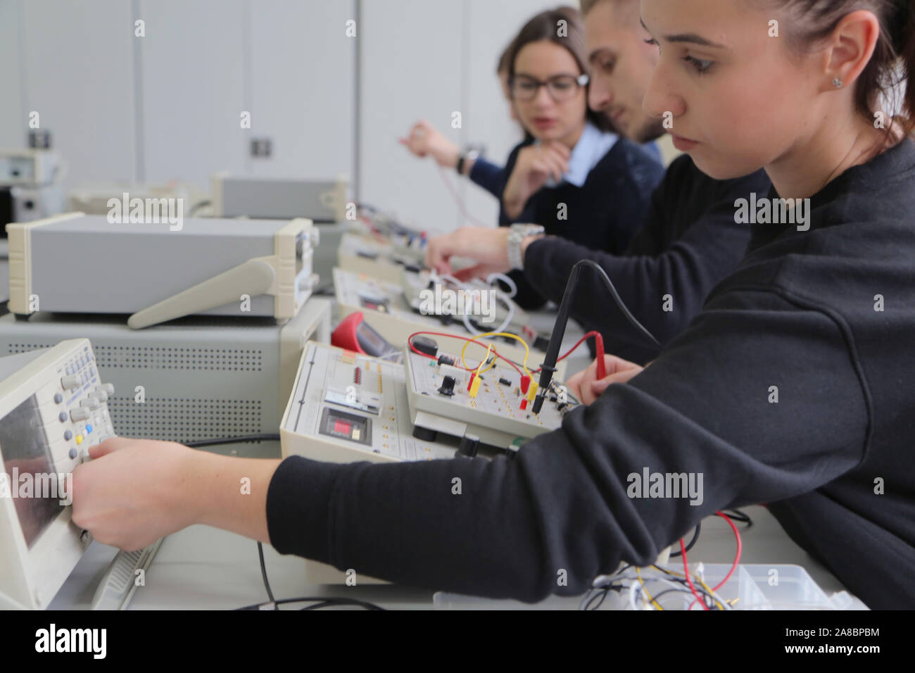 Group of young students in technical vocational training with teacher ...