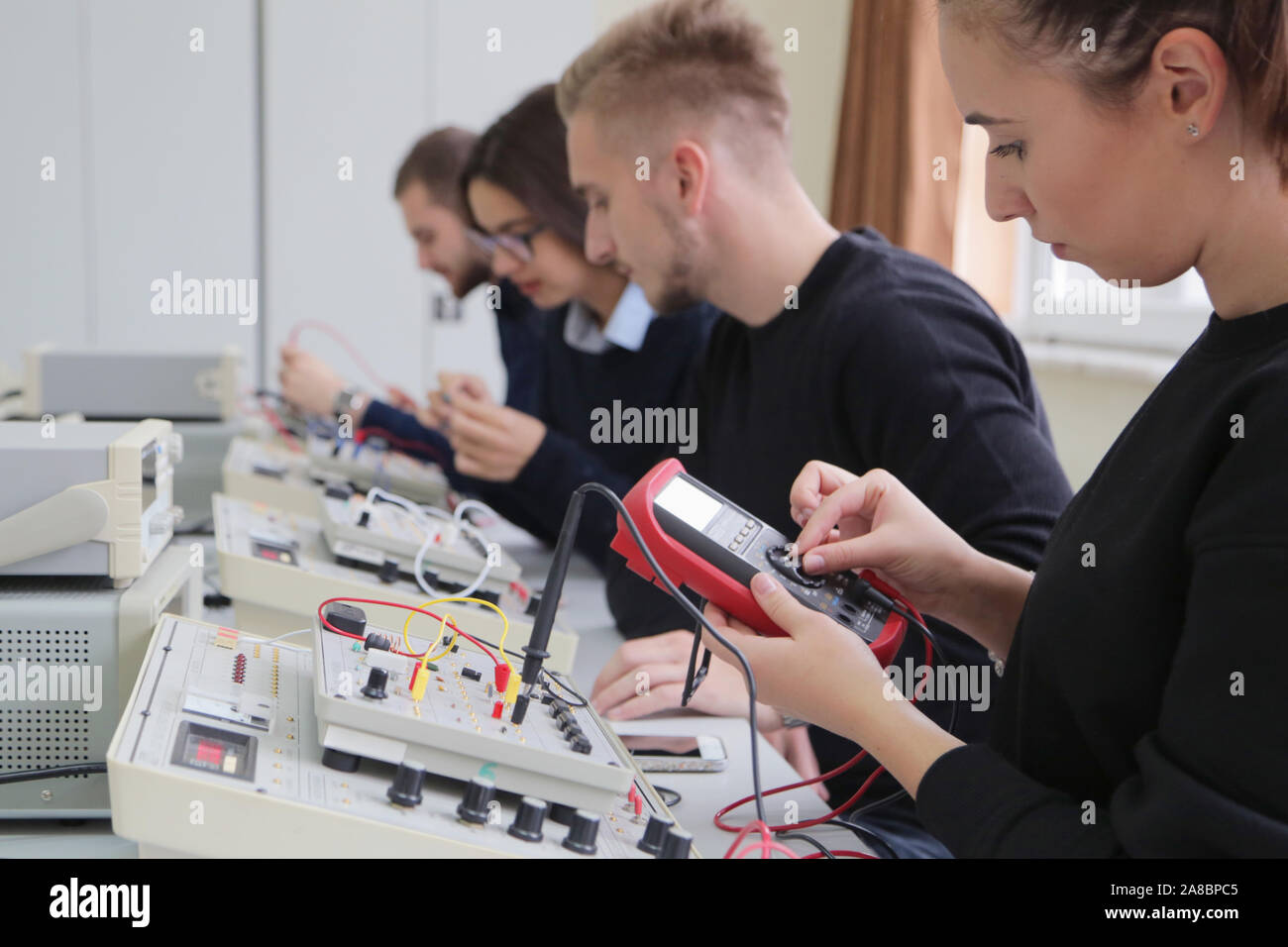 Group of young students in technical vocational training with teacher ...