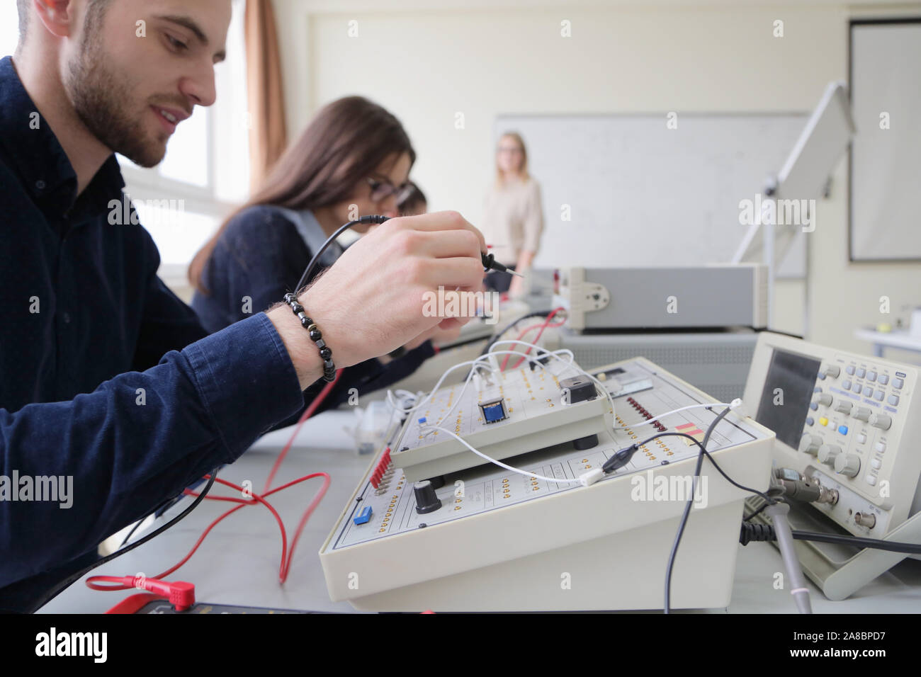 Group of young students in technical vocational training with teacher ...