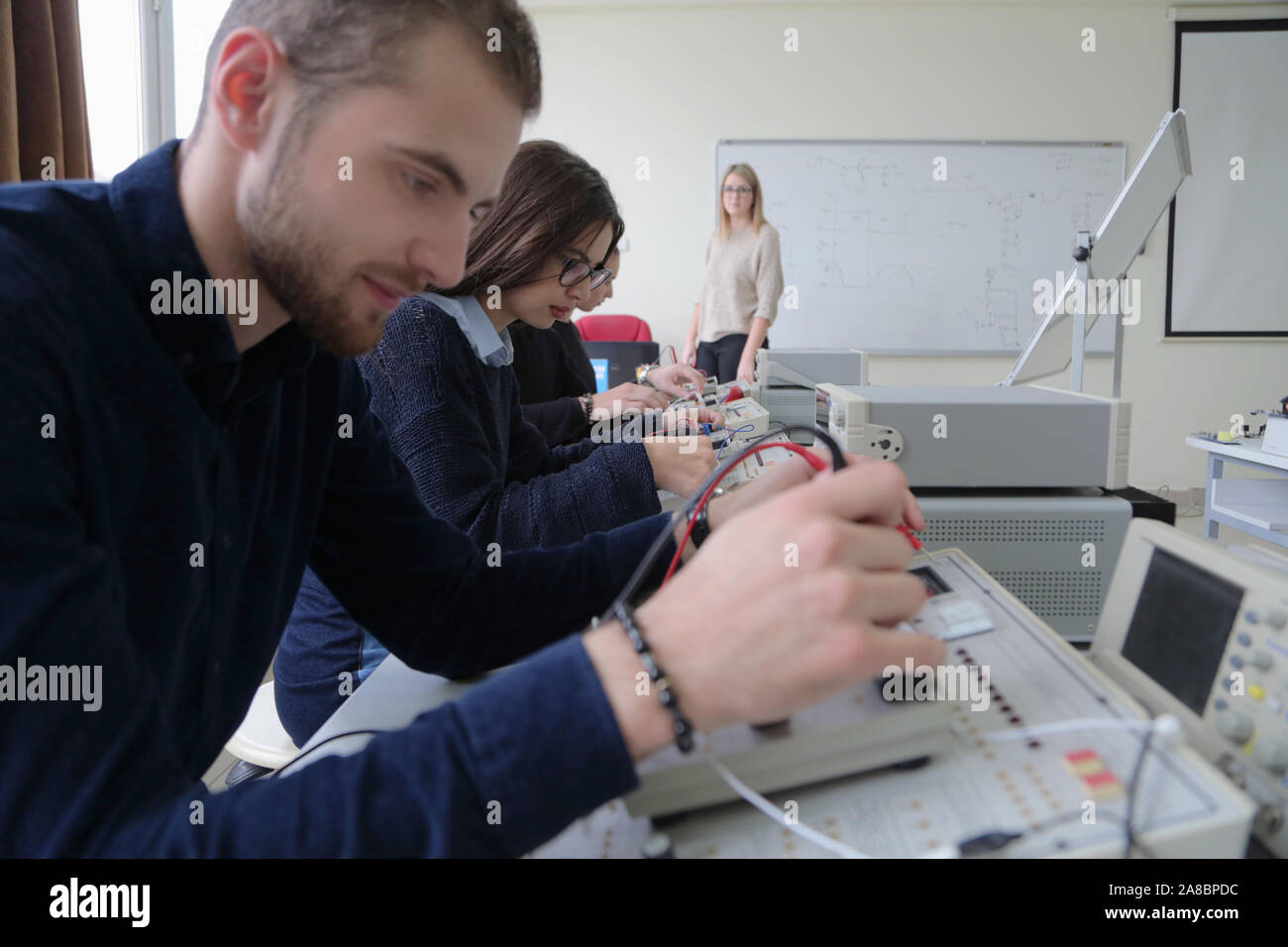 Group of young students in technical vocational training with teacher ...