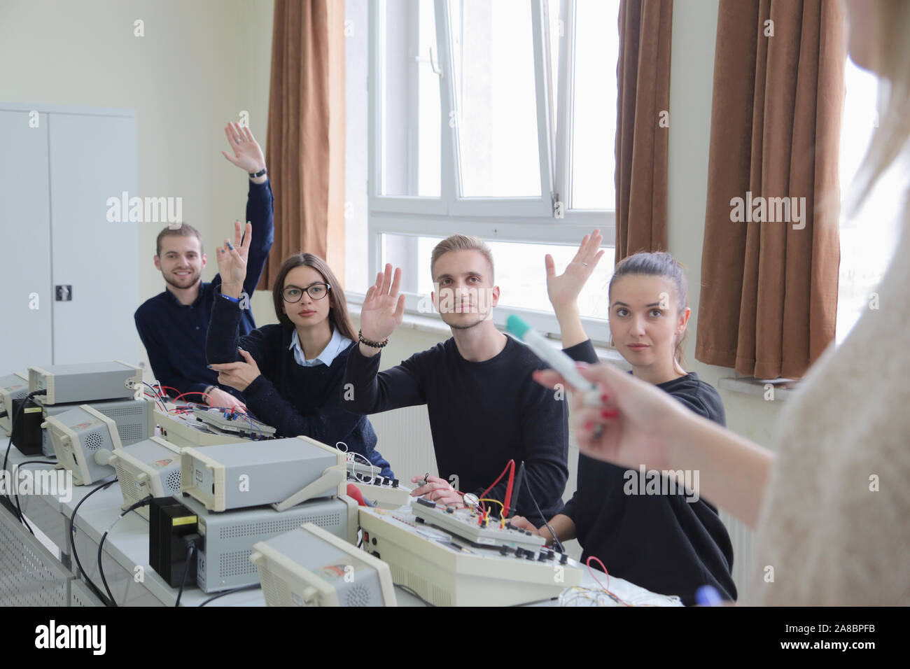 Group of young students in technical vocational training with teacher ...