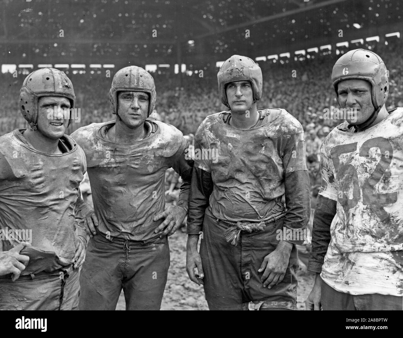 American football players covered in mud after playing a game on a ...