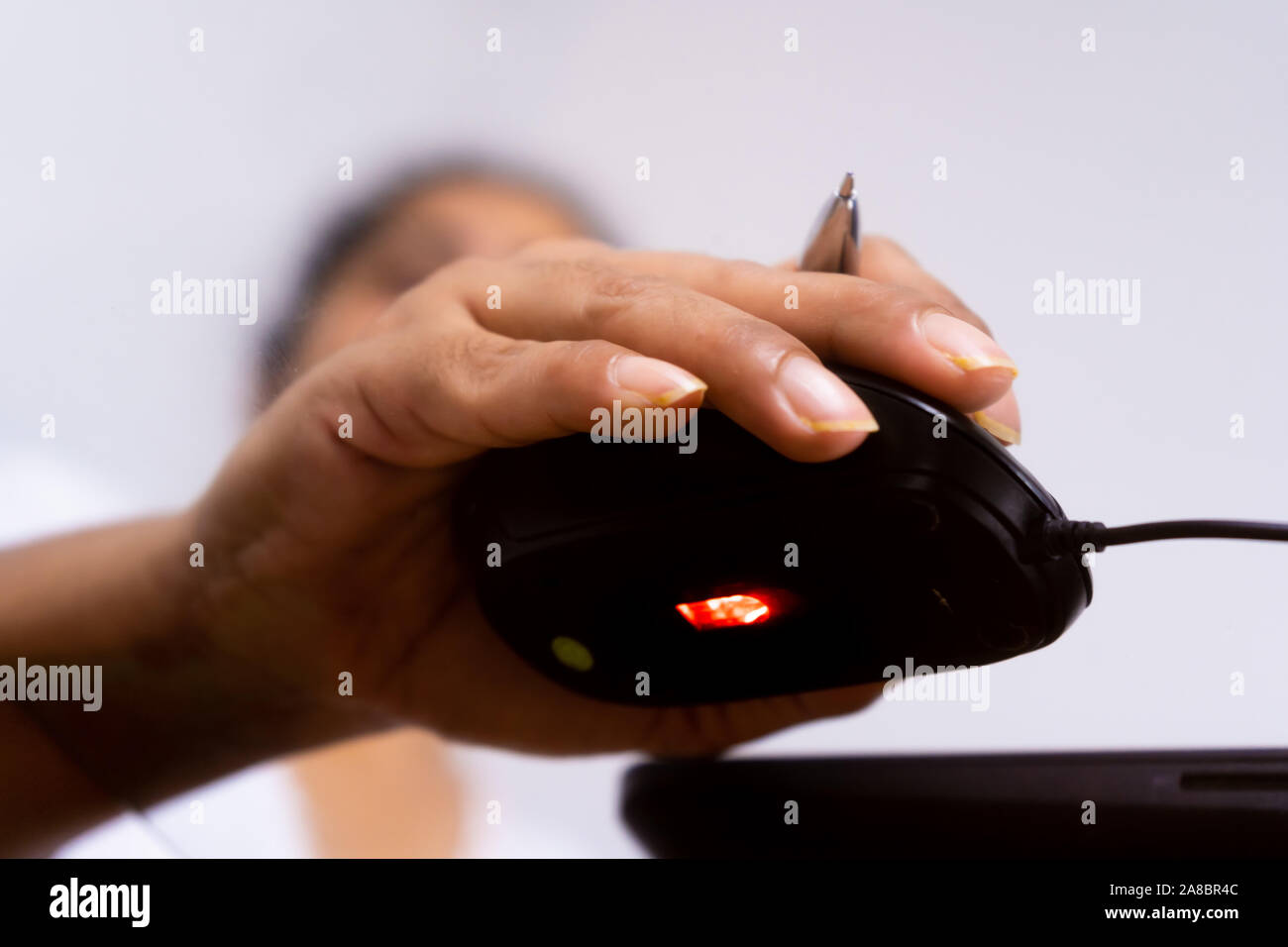 Female hand holding computer mouse Stock Photo - Alamy