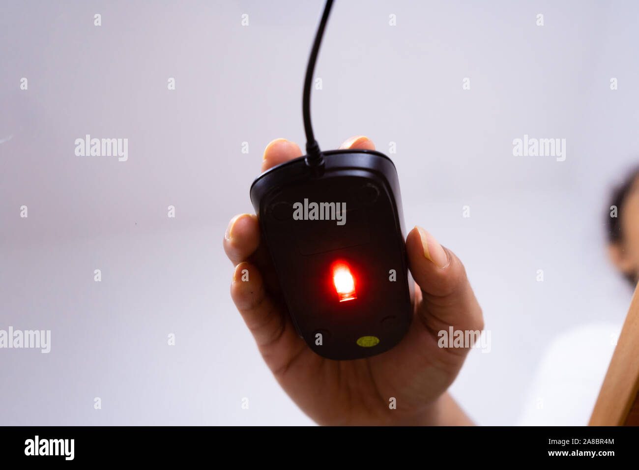 Female hand holding computer mouse Stock Photo - Alamy