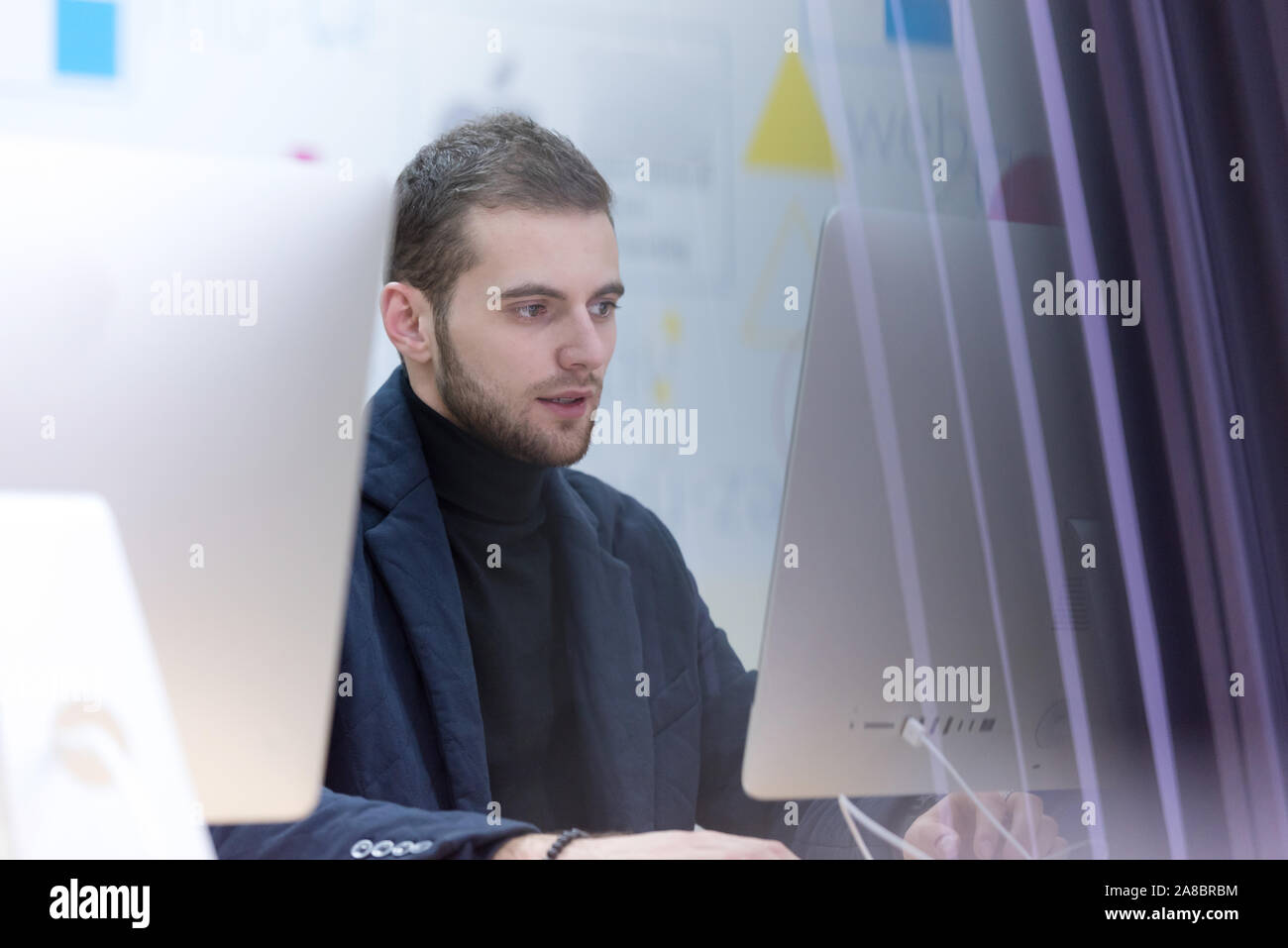 Young male Businessman working on modern computer. Businessman using ...