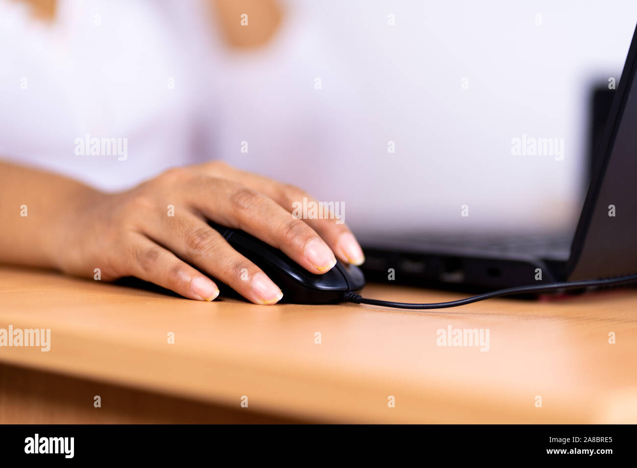 Female hand holding computer mouse Stock Photo - Alamy