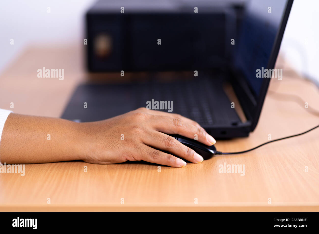 Female hand holding computer mouse Stock Photo - Alamy